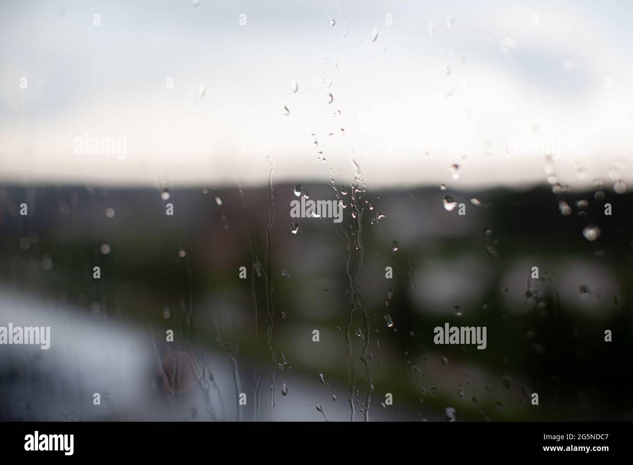 Rainy day through the window on sky and city buildings background Stock ...