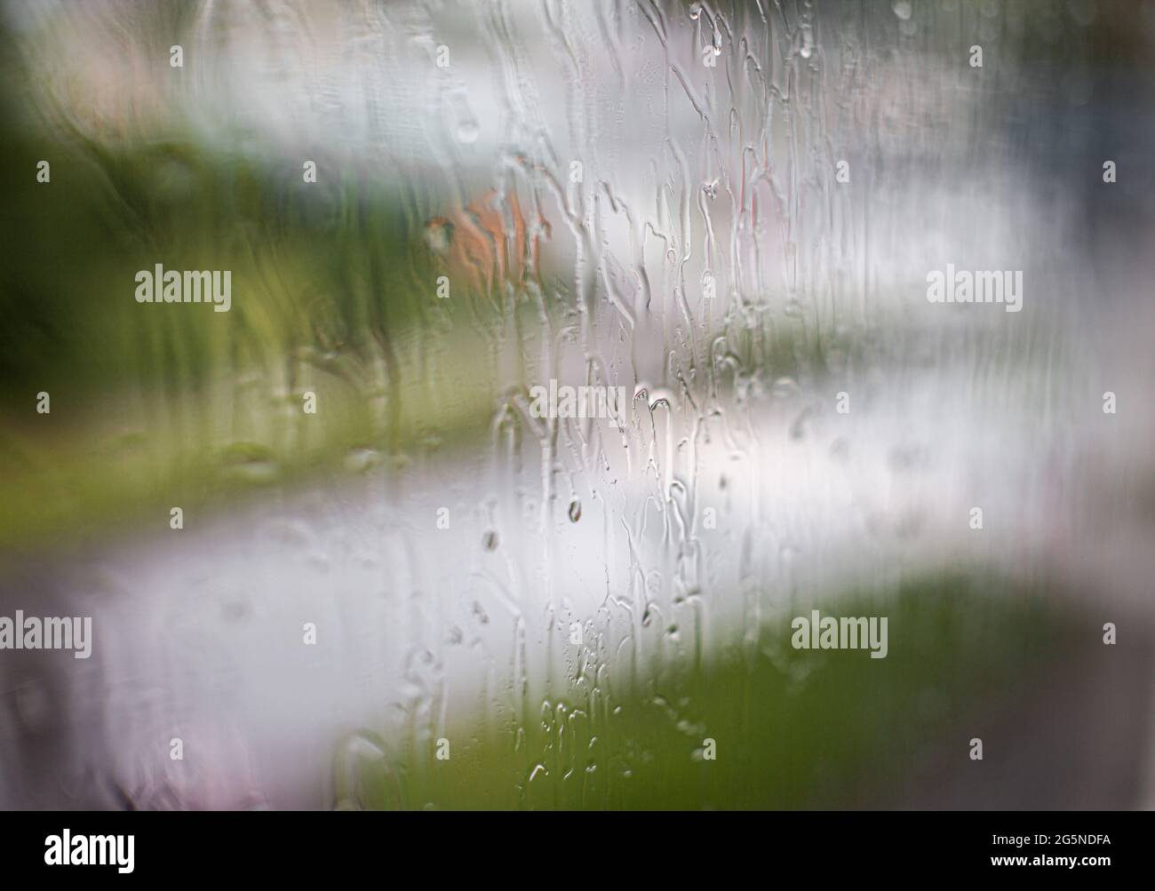 Rainy day through the window on sky and city buildings background Stock ...