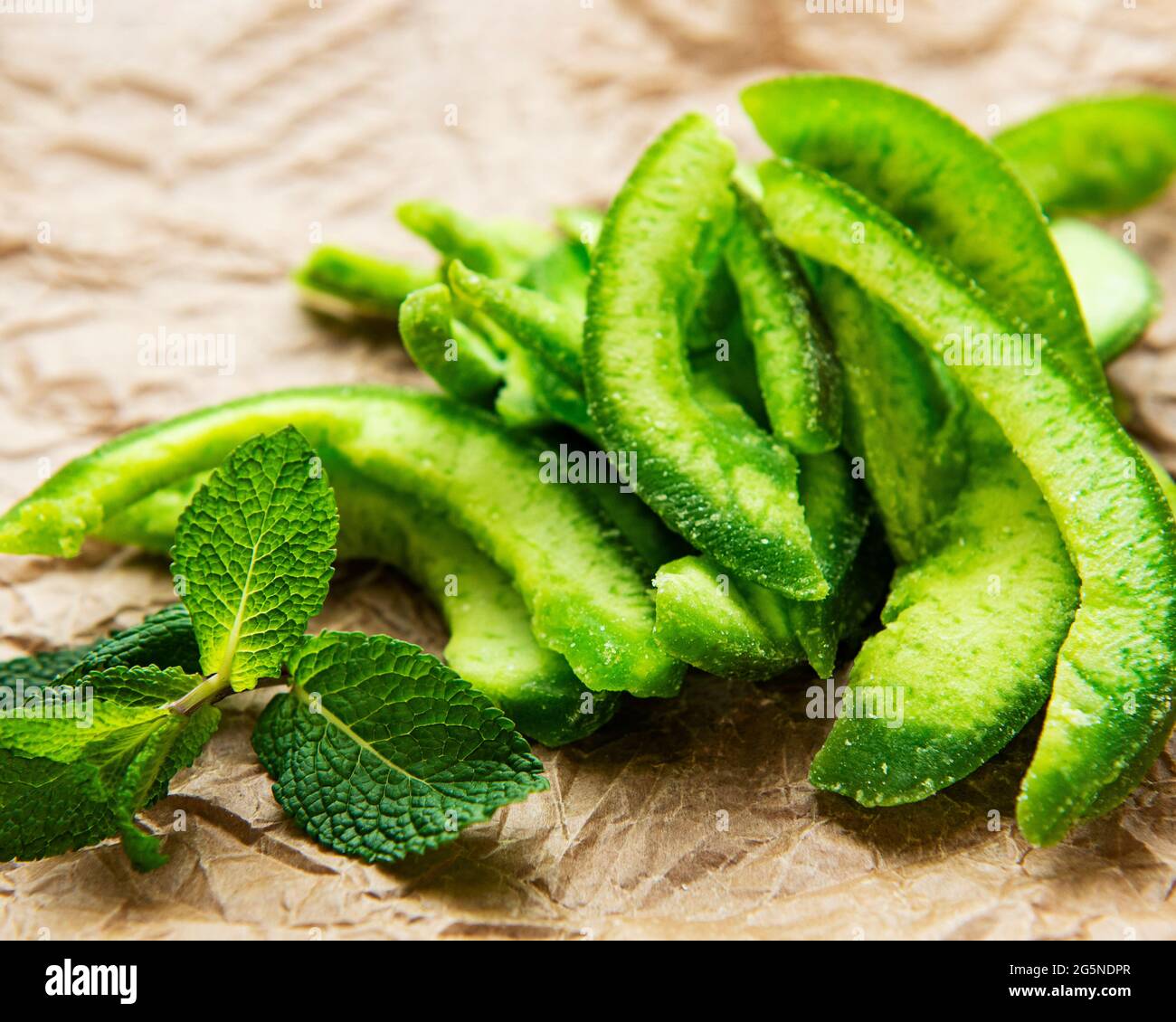 Dry chunks of pomelo on a plate on a brown paper background Stock Photo ...