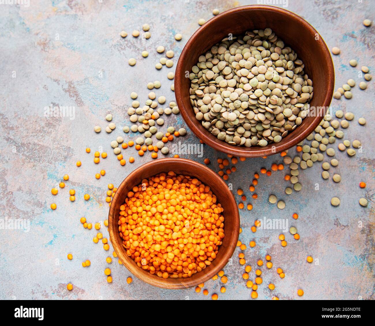 Different raw lentils on a grey concrete background Stock Photo - Alamy