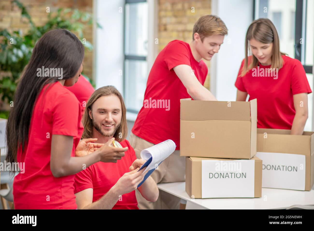 Group of student volunteers engaged in charity center Stock Photo - Alamy