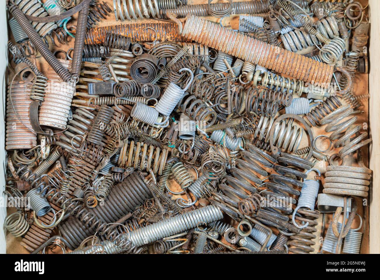 Many various rusty size compression springs. Close-up Stock Photo - Alamy