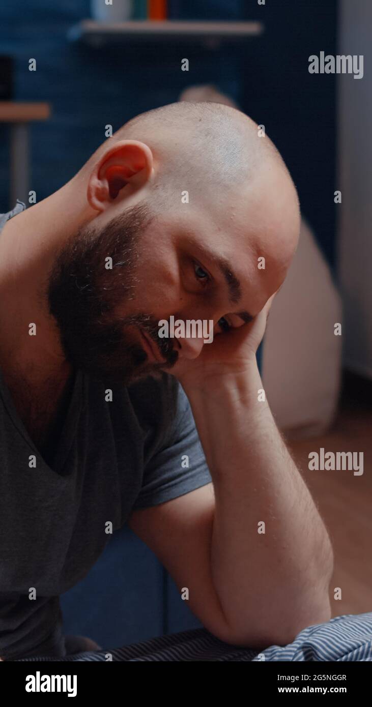 Traumatised, frustrated, vulnerable, depressed man sitting alone ...