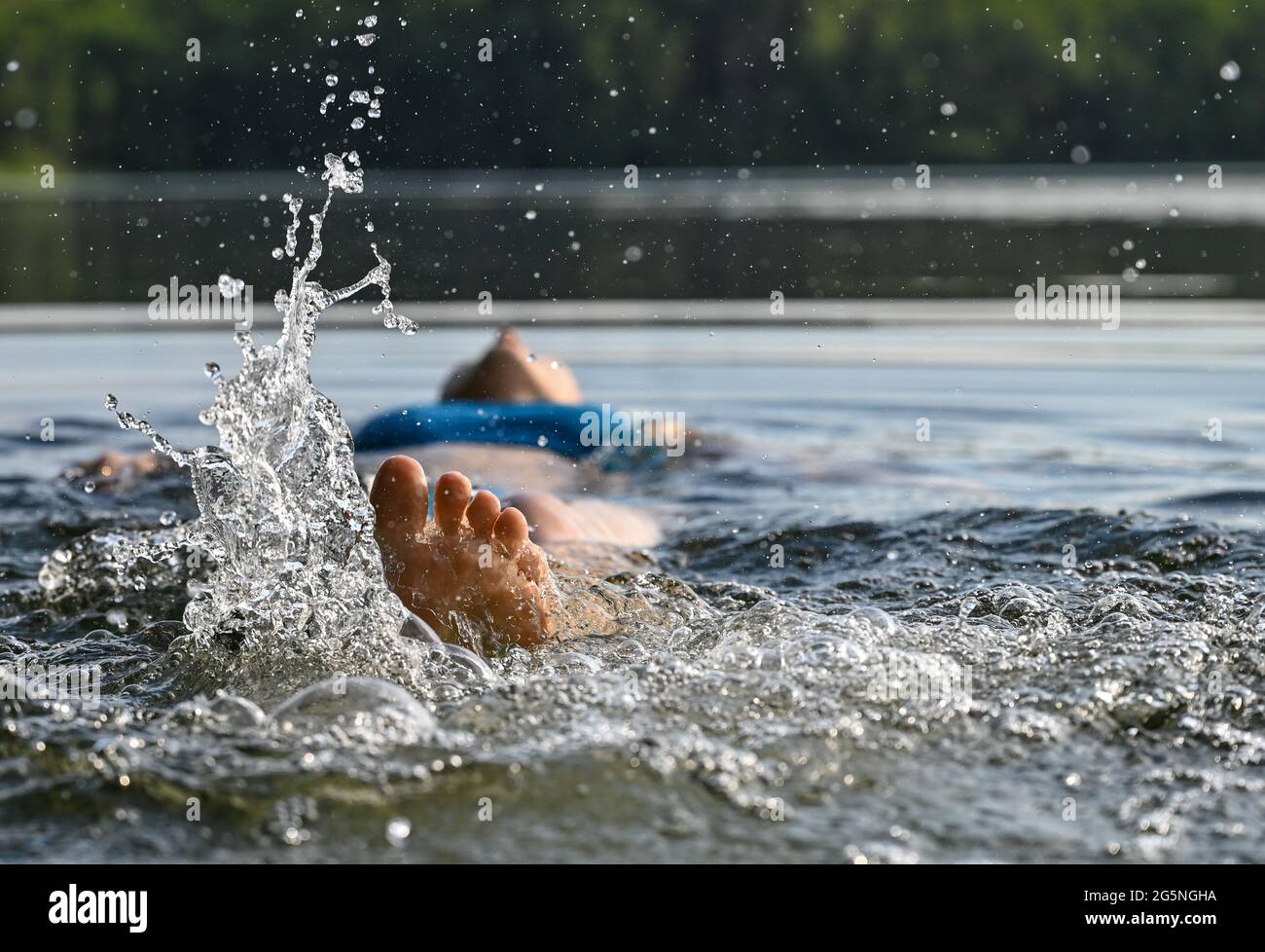 Treplin, Germany. 28th June, 2021. A girl splashes around while ...