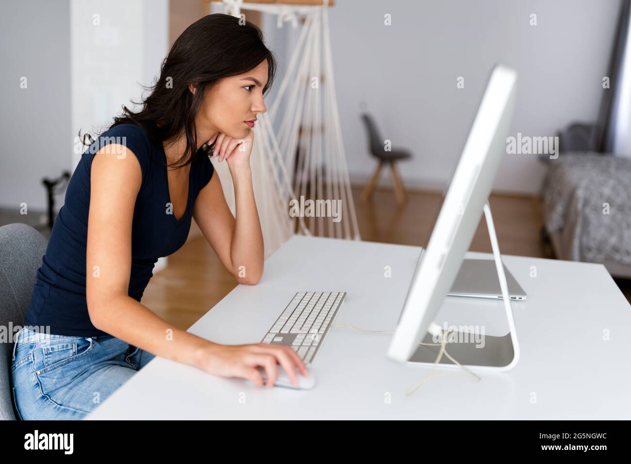 Beautiful student woman learning online on computer at home. Technology ...