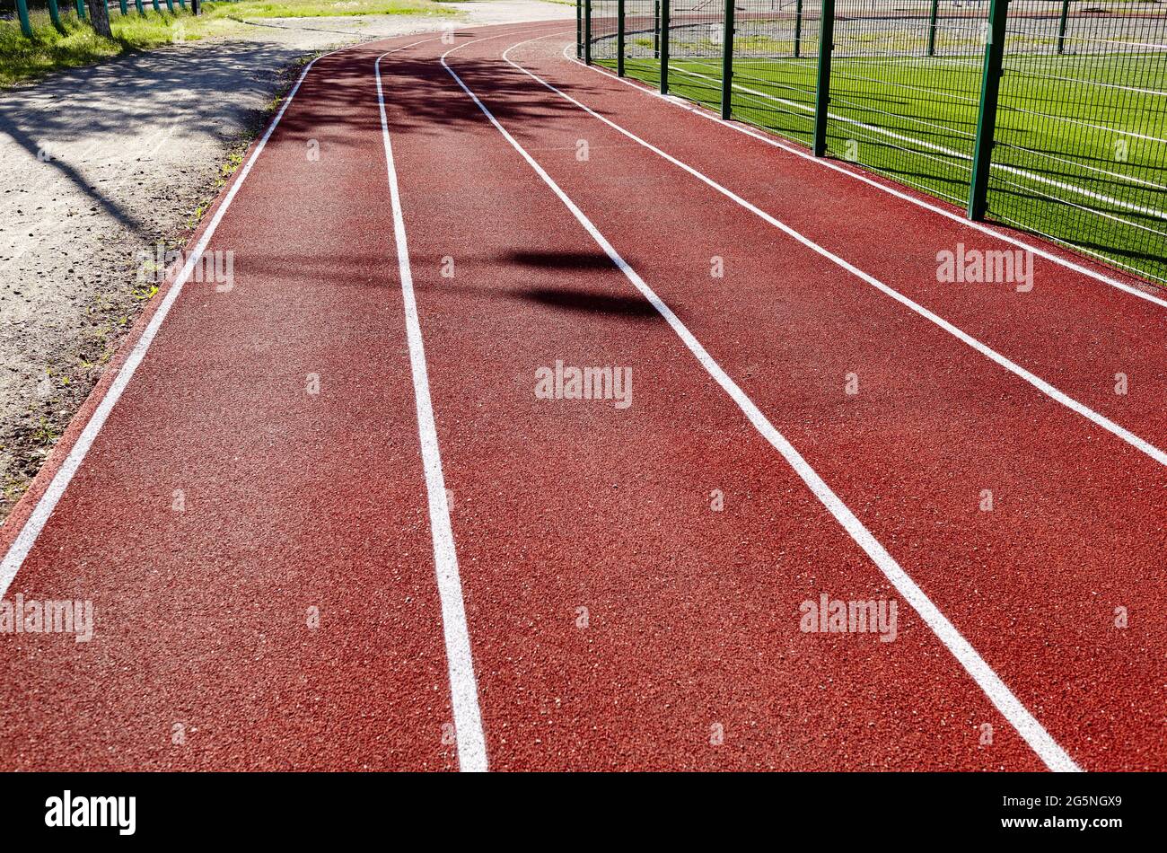 Red treadmill on sport field. Running track on the stadium Stock Photo ...