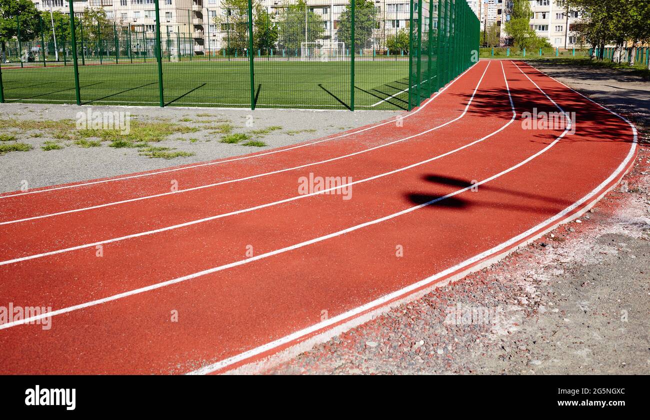 Red treadmill on sport field. Running track on the stadium Stock Photo ...