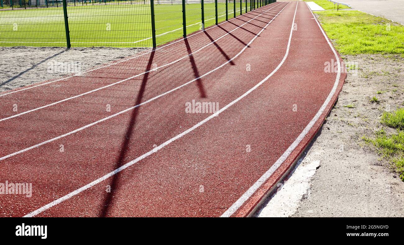 Red treadmill on sport field. Running track on the stadium Stock Photo ...