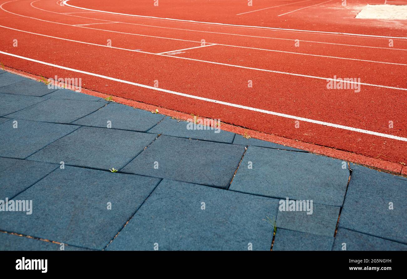 Red treadmill on sport field. Running track on the stadium Stock Photo ...