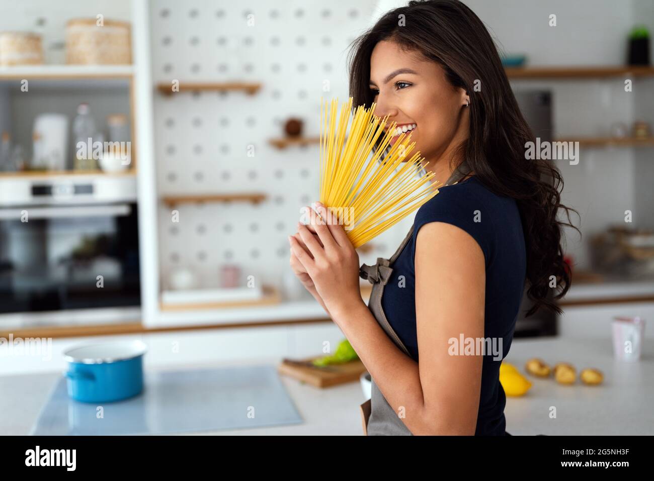 Beautiful girl is going to cook pasta. Healthy lifestyle, food people ...