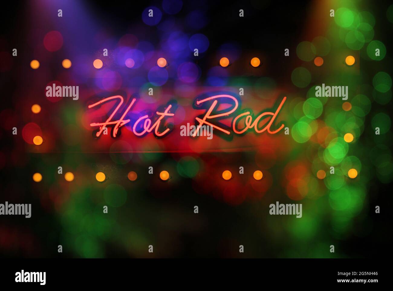 Neon Hot Rod Sign in wet window with vintage hot rod car Stock Photo ...