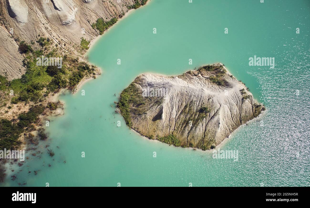 Stone on green lake water aerial above top view Stock Photo - Alamy