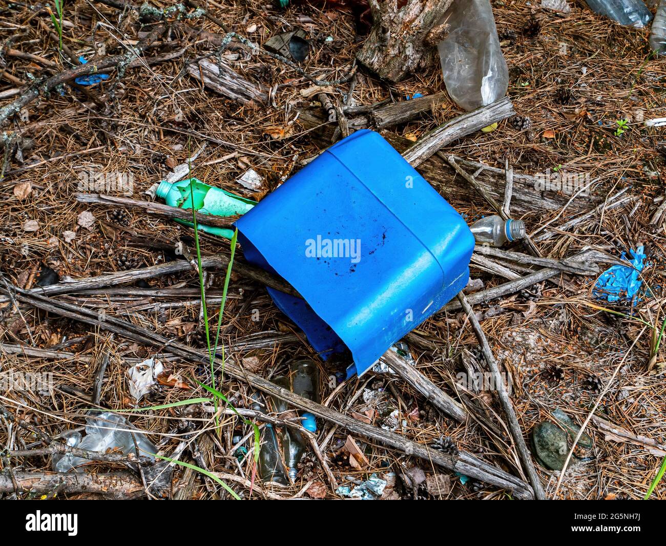 A blue plastic canister in a landfill. Container for chemicals ...