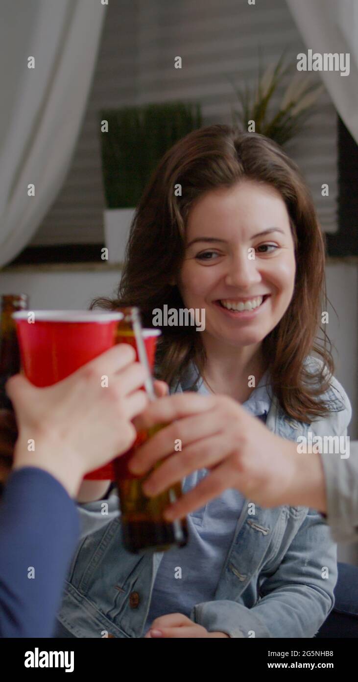 Multiethnic friends gathering late at night in living room while ...