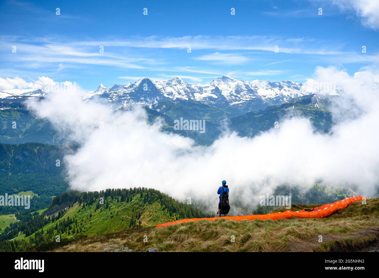 starting paragliding flyer in the Bernese Alps in front of Eiger Mönch ...