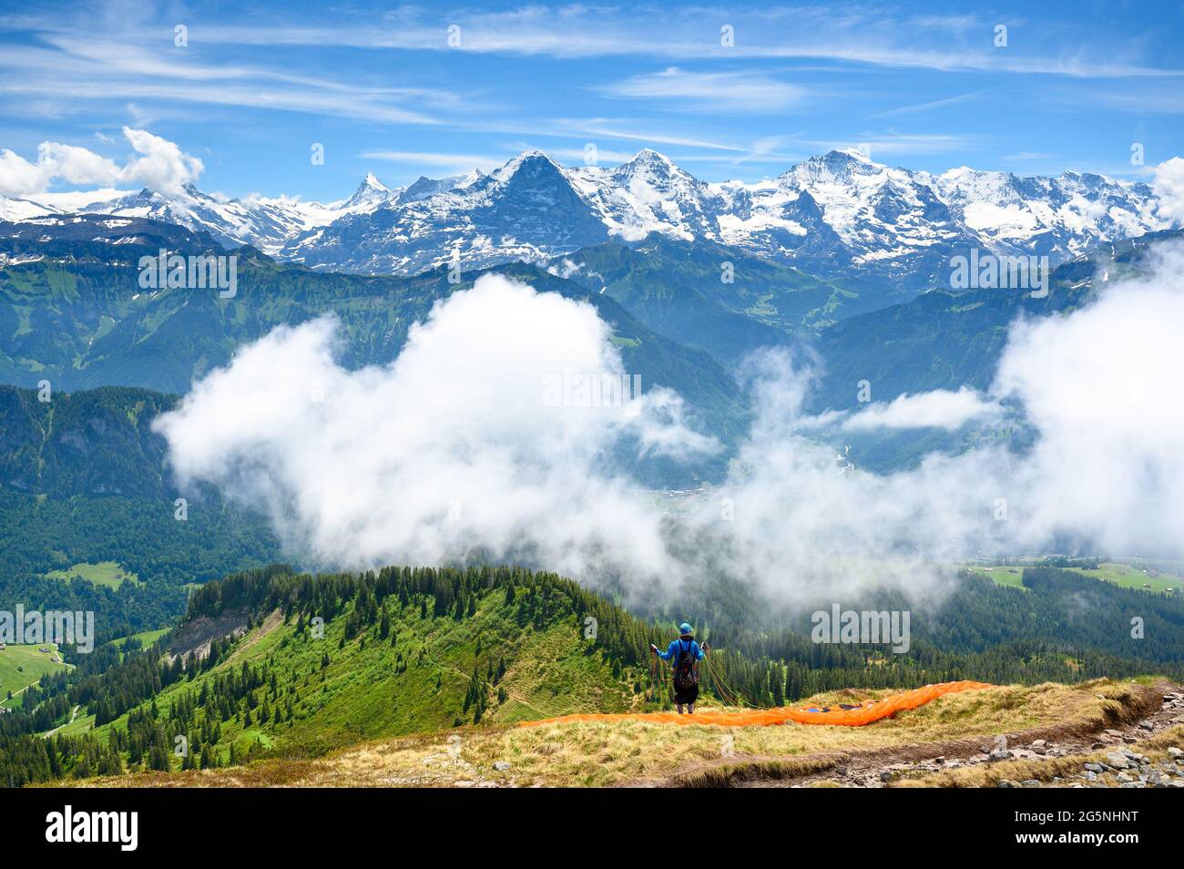starting paragliding flyer in the Bernese Alps in front of Eiger Mönch ...