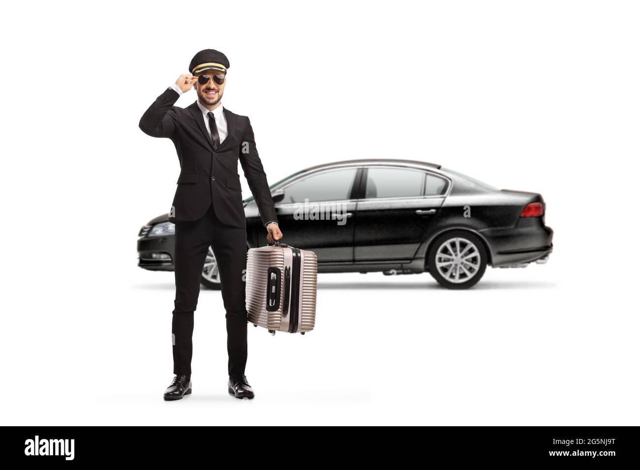 Full length portrait of a chauffeur carrying a suitcase and greeting ...