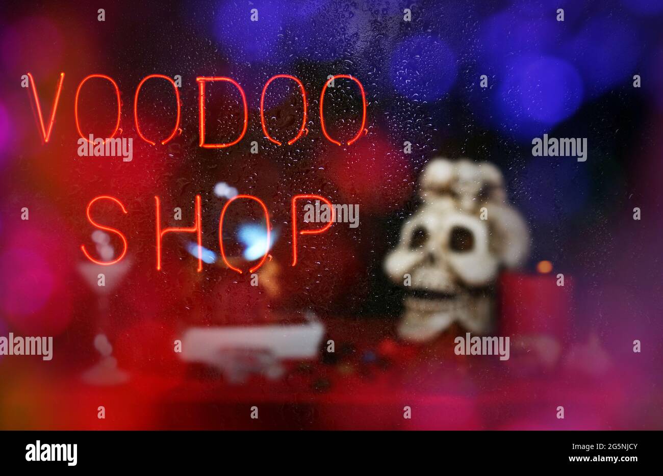 Voodoo Shop Sign in Rainy Window with blurred skull Stock Photo - Alamy
