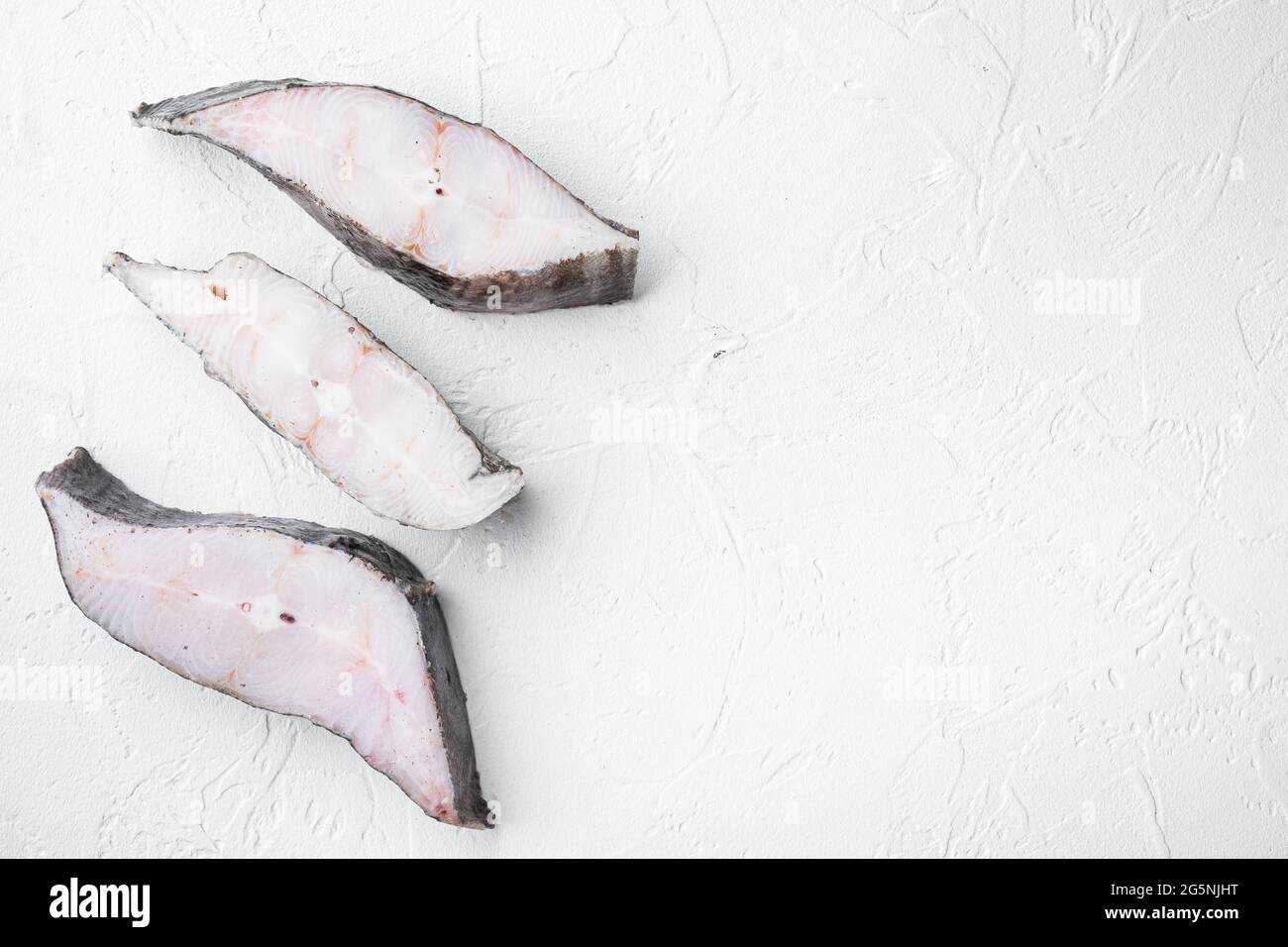 Frozen fish cut set, on white stone table background, top view flat lay ...