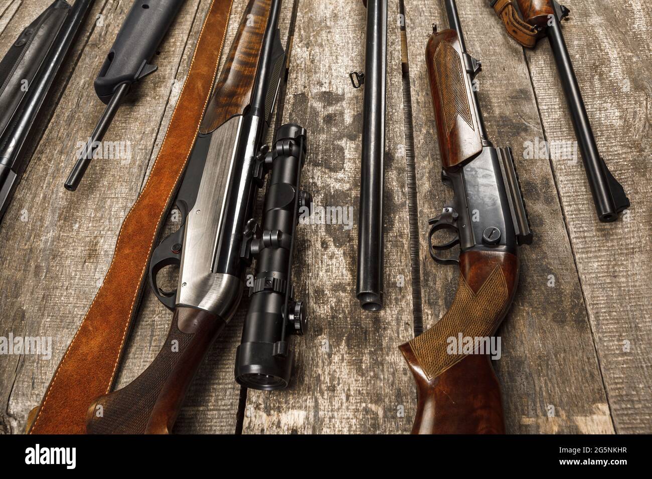 Many hunting rifles on weathered wooden surface Stock Photo - Alamy