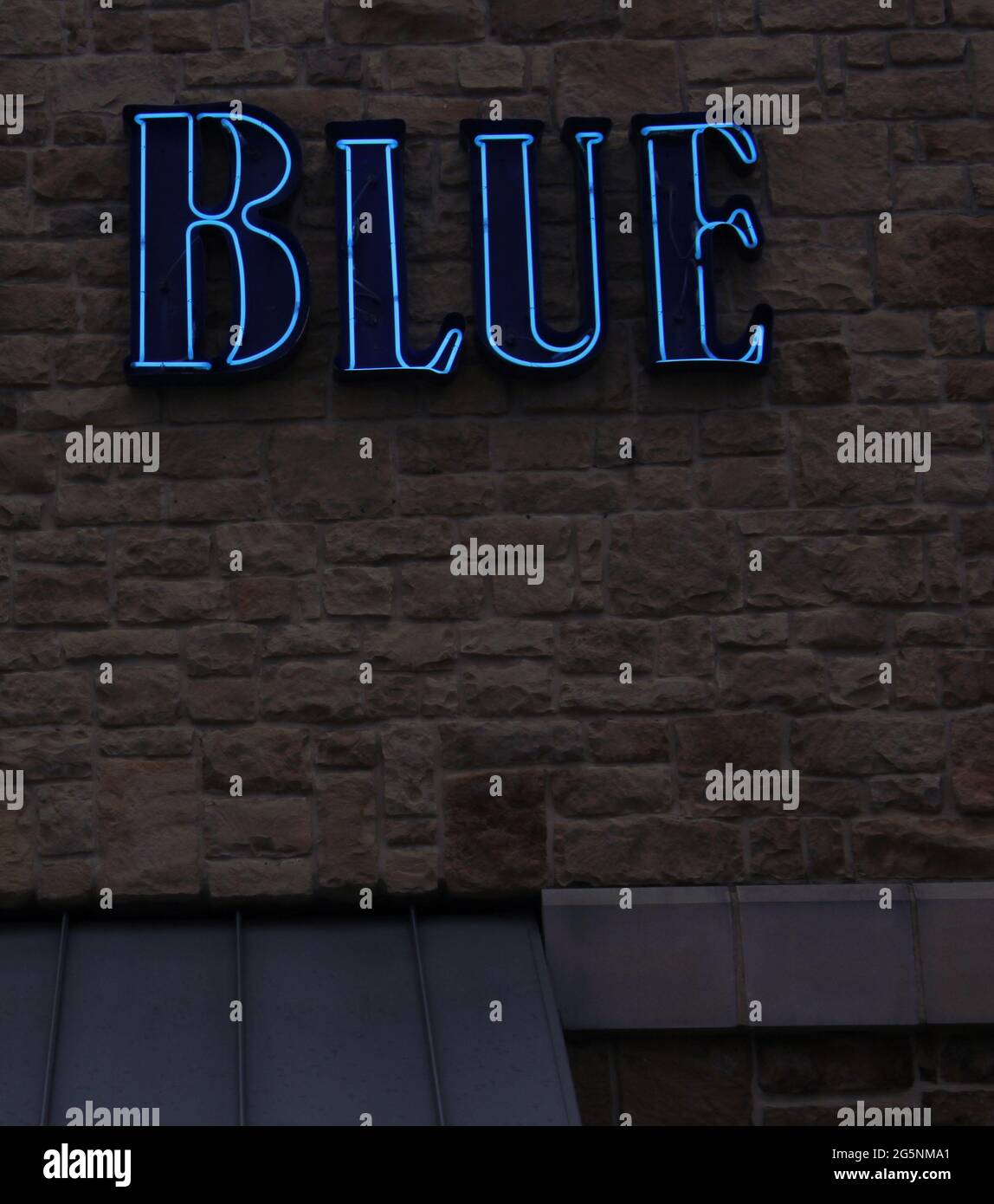 Vintage Neon Sign on Brick Wall, Blue Stock Photo - Alamy
