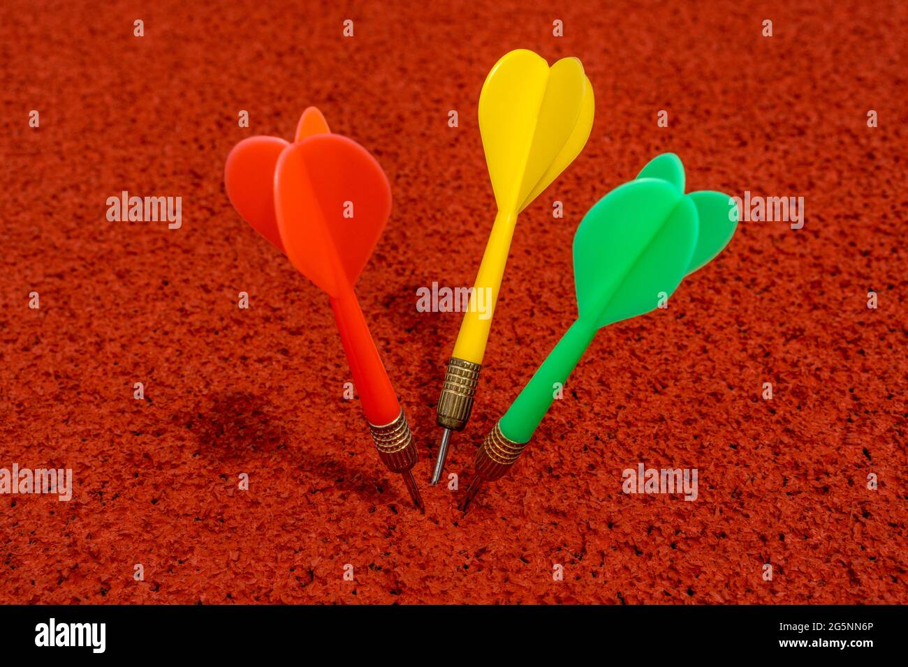 Red, green and yellow colored dart arrows on a running track in a ...