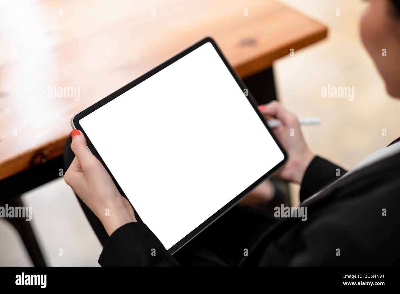 Close-up of woman working with stylus on digital tablet pc with blank ...