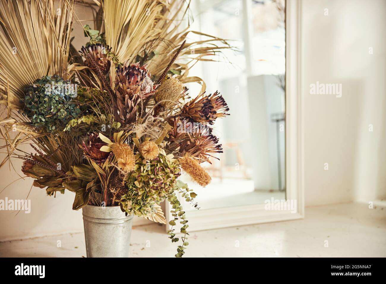 Large bouquet of natural flowers placed in a galvanized metal bucket ...