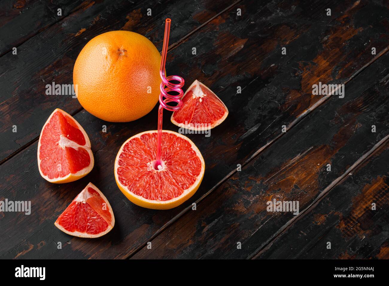 Grapefruit citrus fruit with half set, on old dark wooden table ...