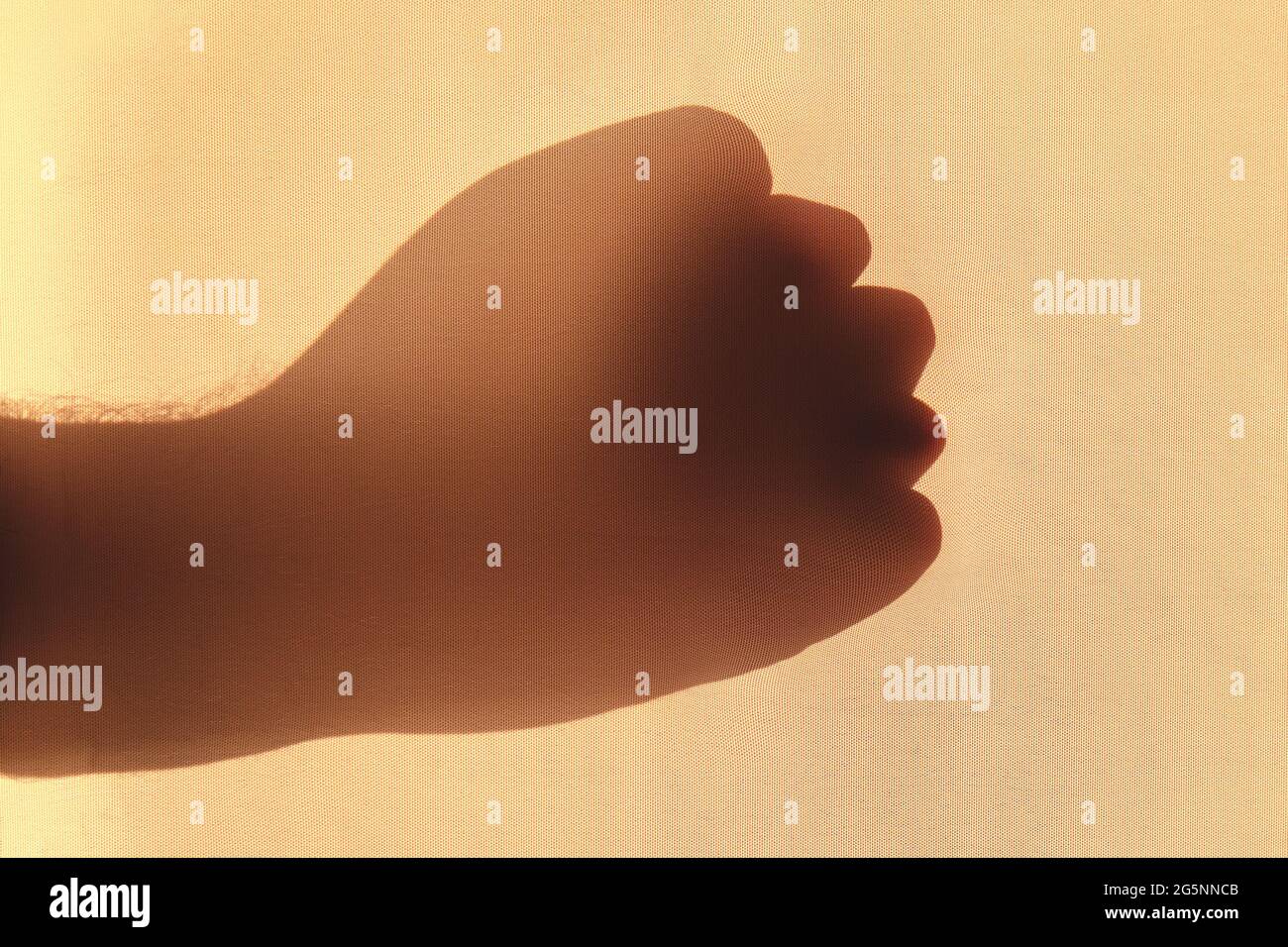 Shadow of a man hand shows a fist gesture, silhouette Stock Photo - Alamy