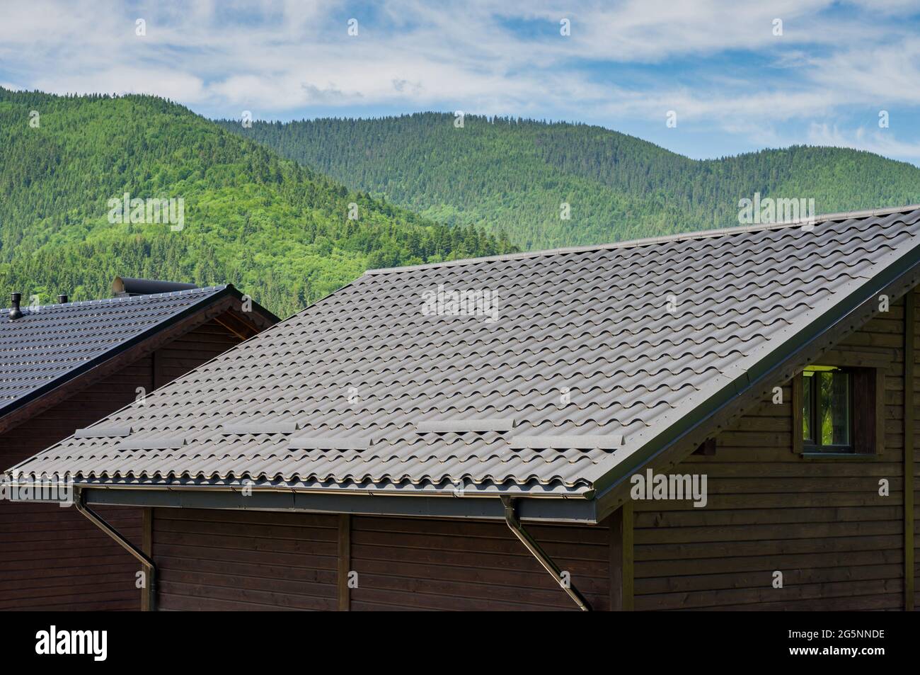 Metal roof construction on a wooden house against a background of ...