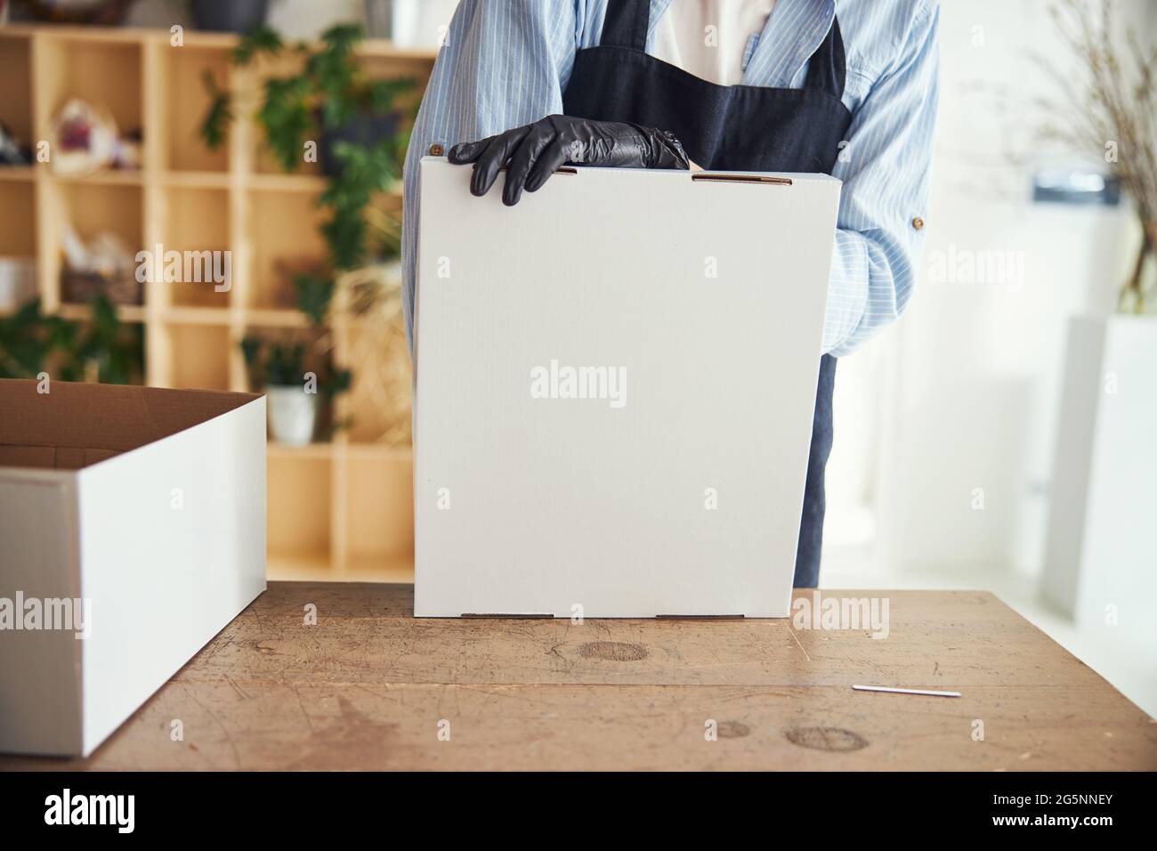Person folding cardboard box hi-res stock photography and images - Alamy