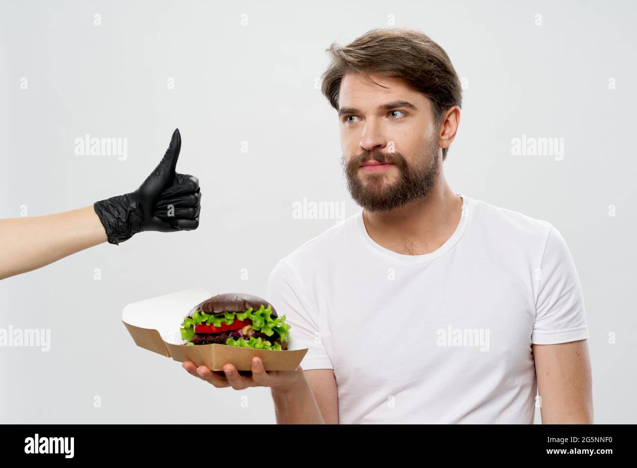 man holding fast food delicious food lifestyle snack Stock Photo - Alamy