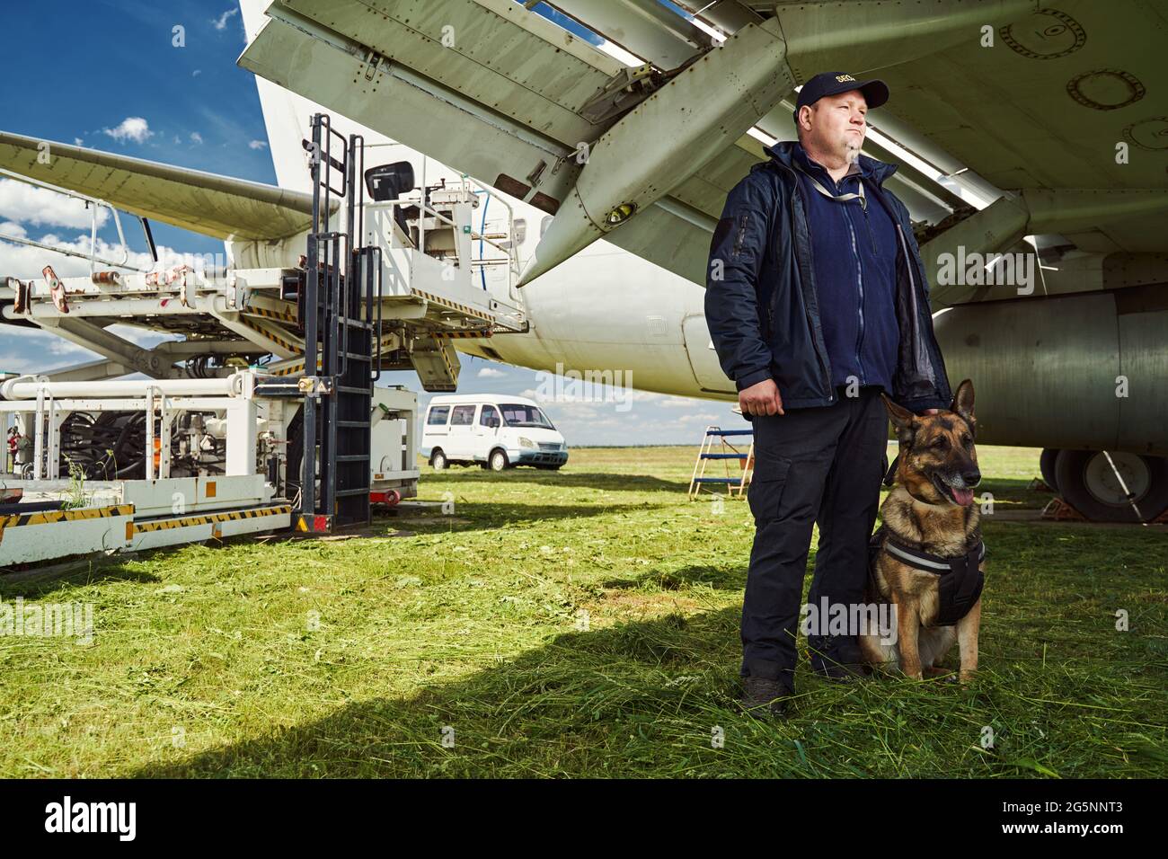 Male security officer with dog standing outdoors at airfield Stock ...