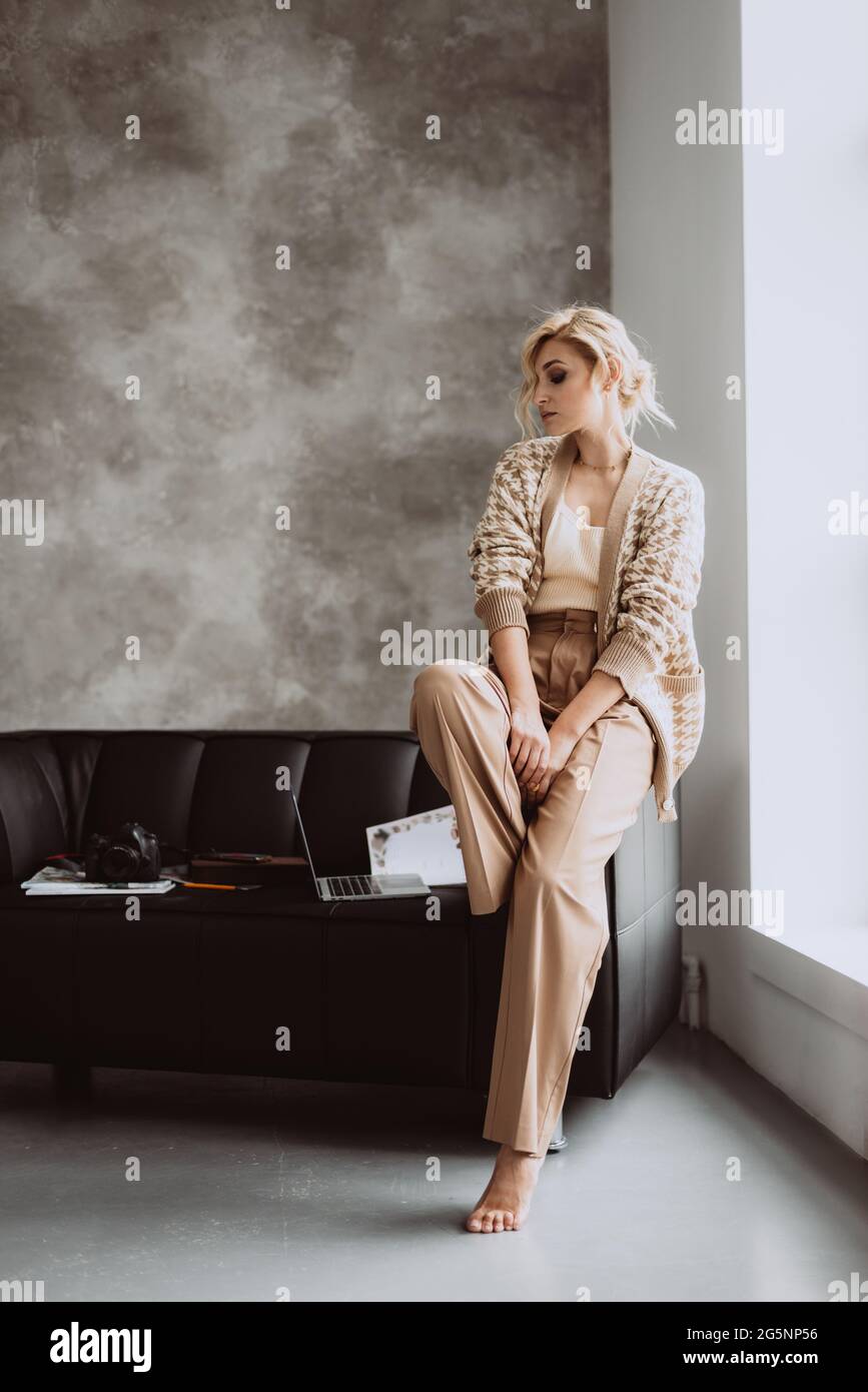 Young beautiful woman blogger in a modern loft interior. Woman ...