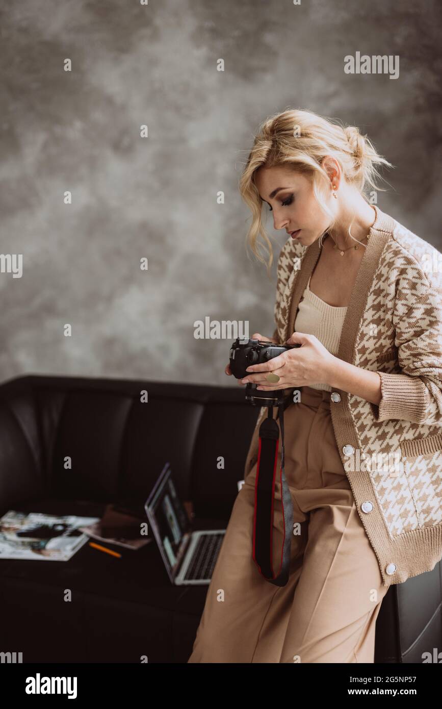 Young beautiful woman blogger in a modern loft interior. Woman ...