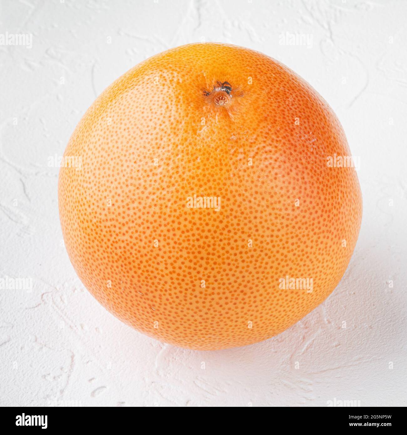Ripe Grapefruit set, square format, on white stone table background ...