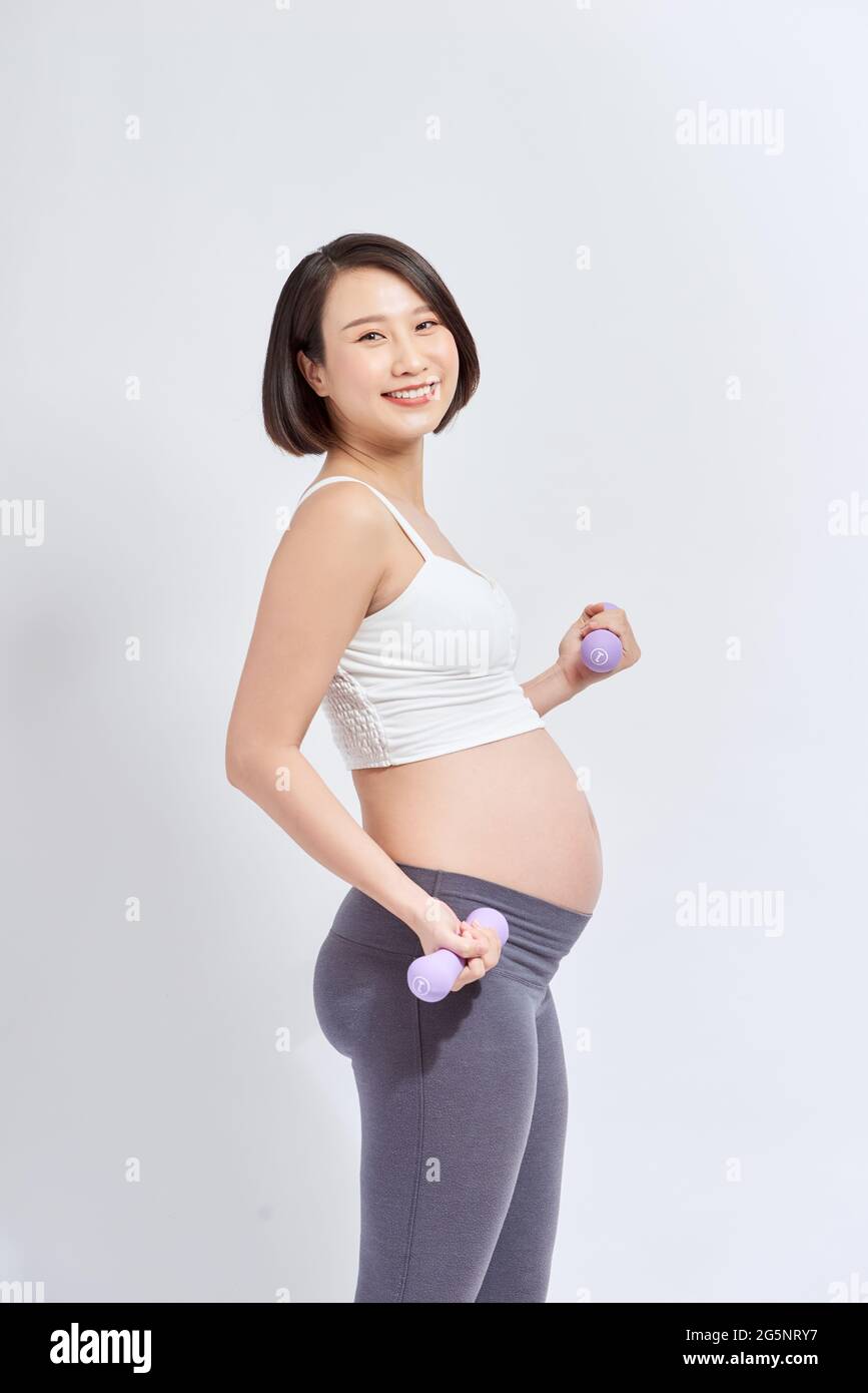 Asian Pregnant Woman Do Exercise Standing And Lifting Dumbbells