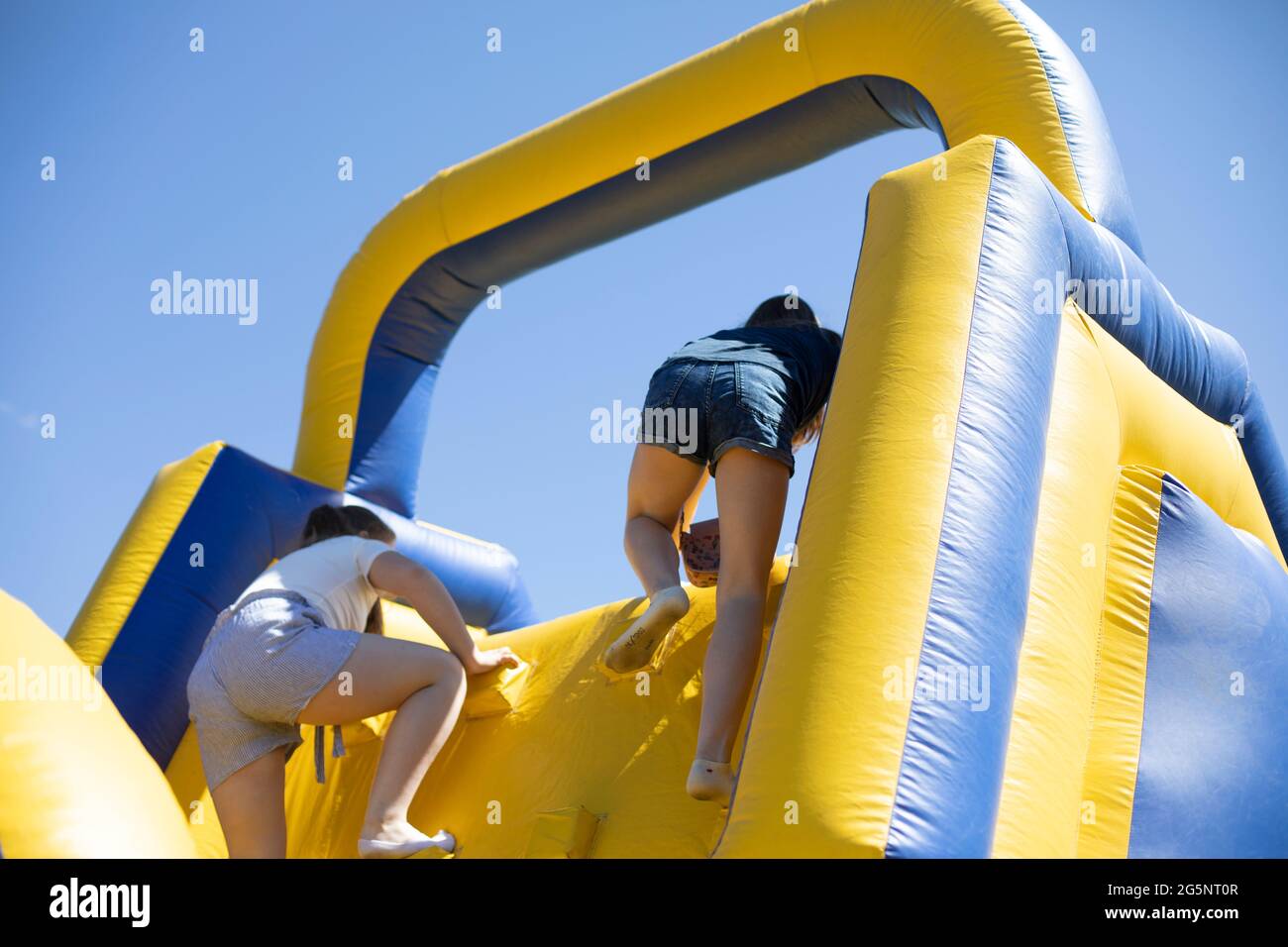 Children climb an inflatable slide. Inflatable obstacle course for fun ...