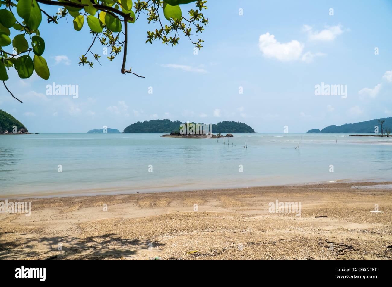 Small tropical island with trees and rocks in the middle of sea and ...