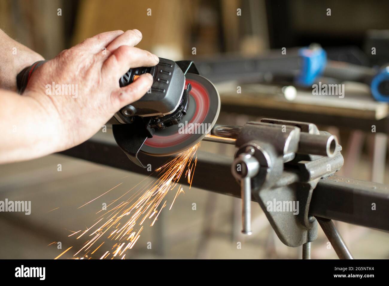 Metal grinding. Steel processing with power tools. A man is working on ...