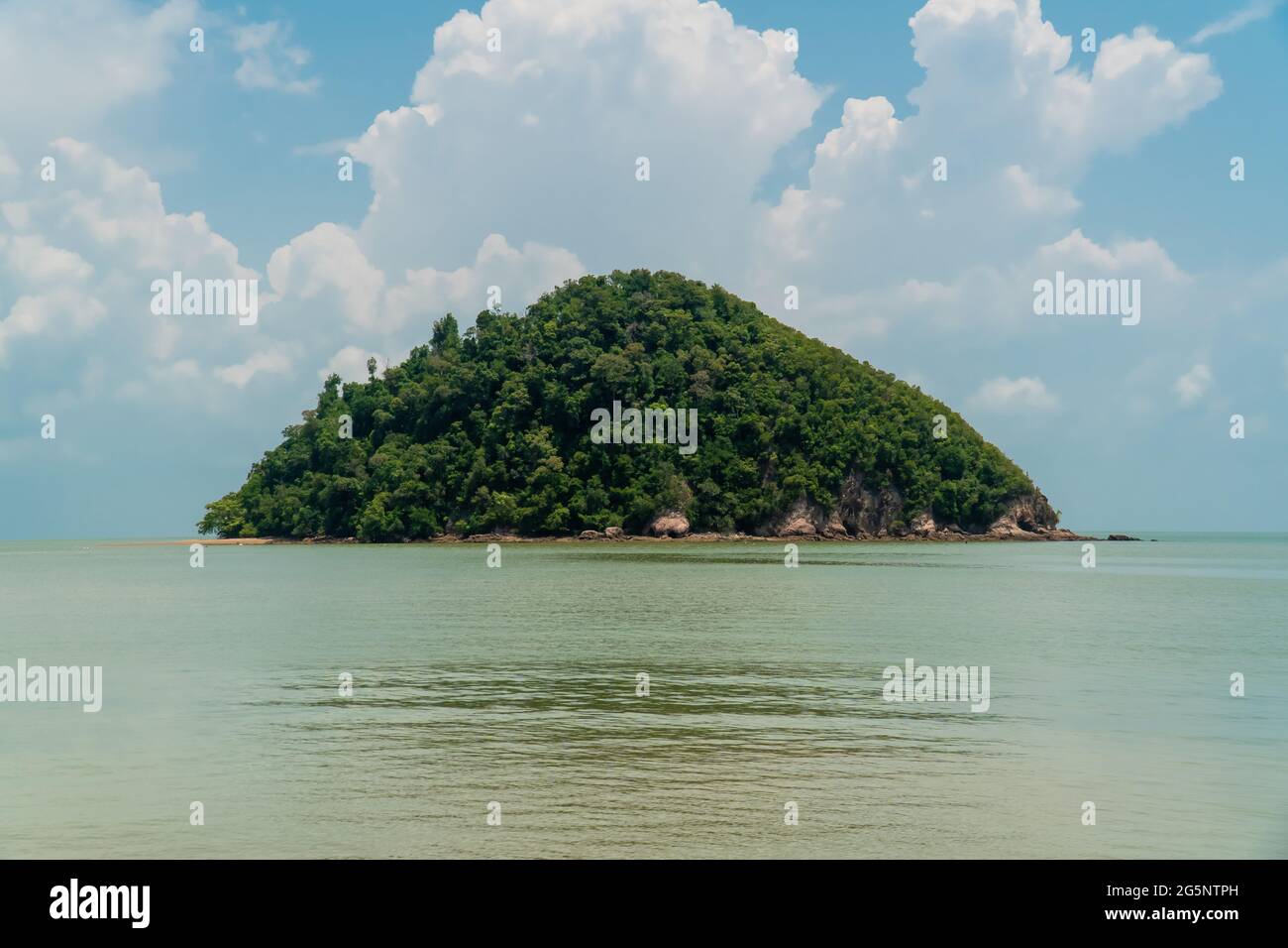 Small tropical mountain island with trees and rocks in the middle of ...
