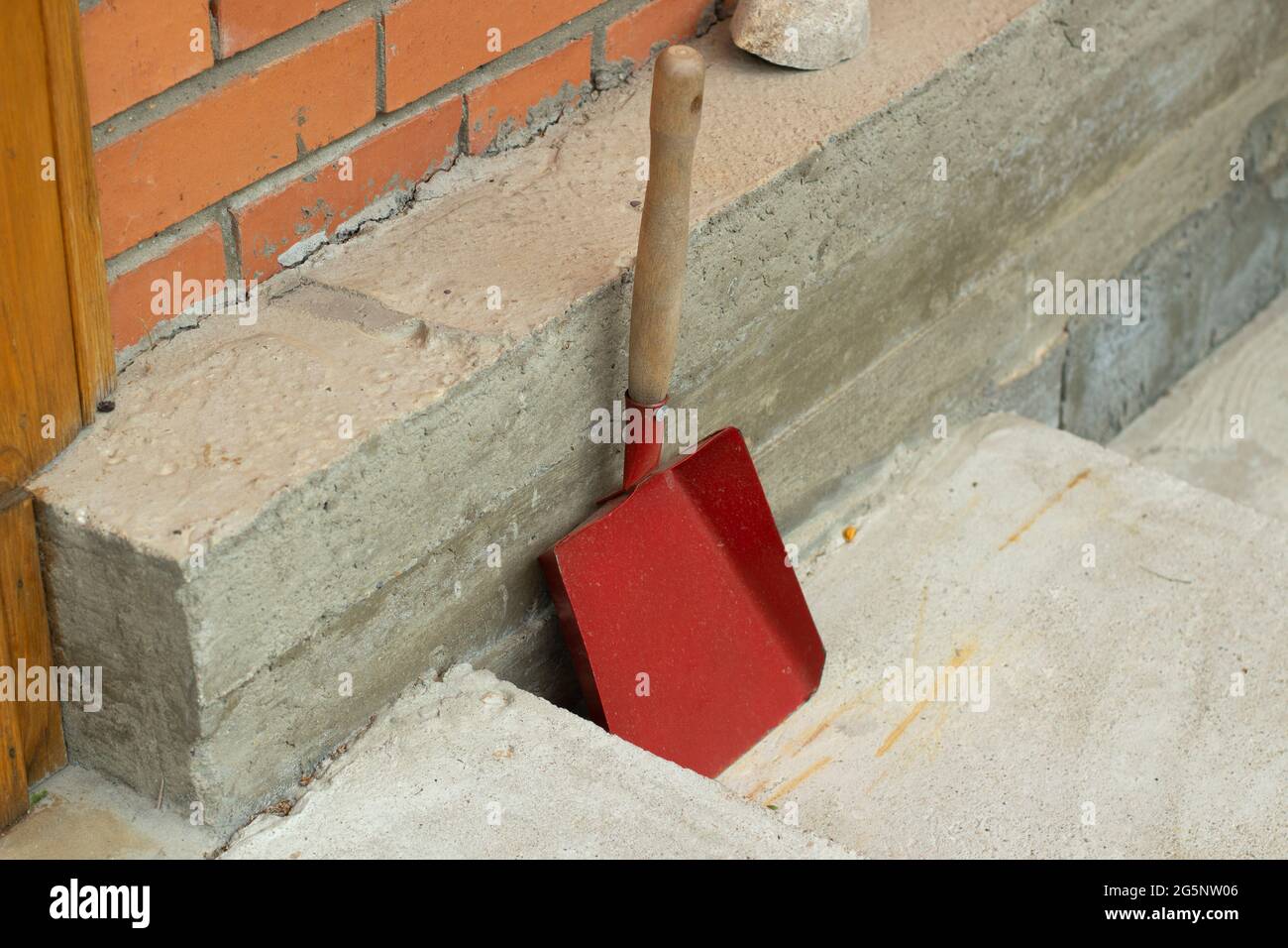 Garbage scoop. The scoop is against the wall. The classic maid's tool ...