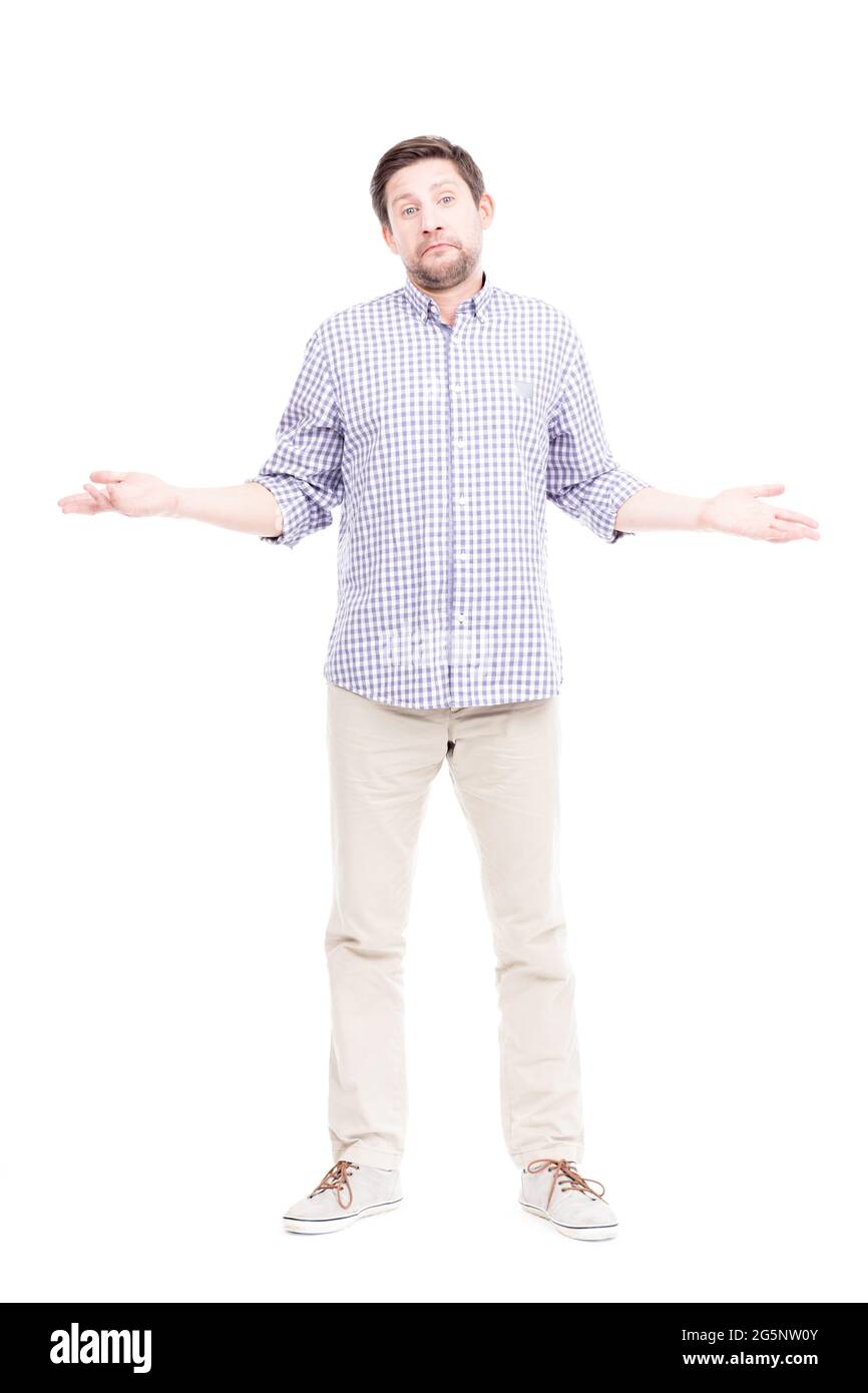 Vertical full length portrait shot of confused Caucasian man wearing ...