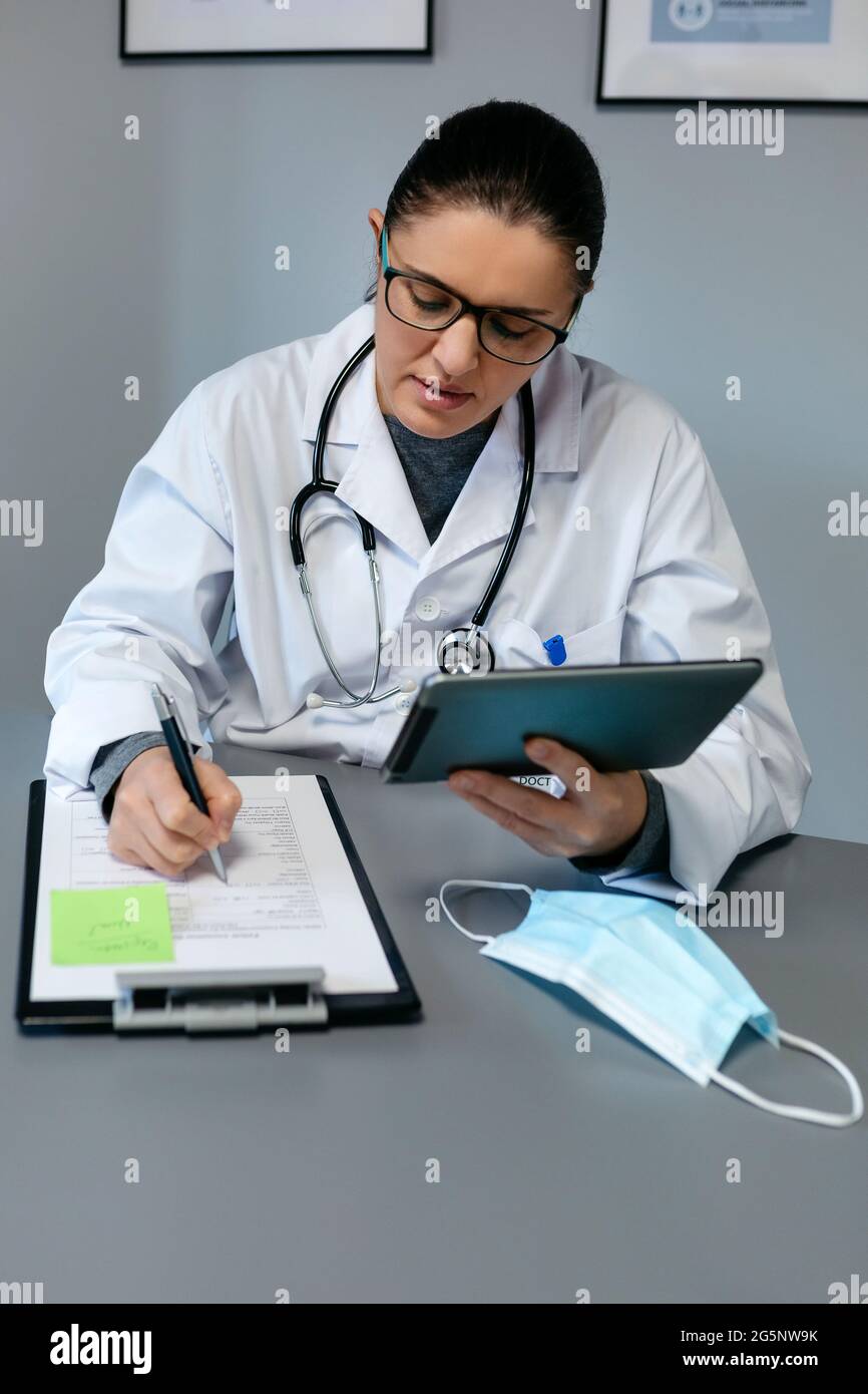 Female doctor doing online consultation with the tablet Stock Photo - Alamy