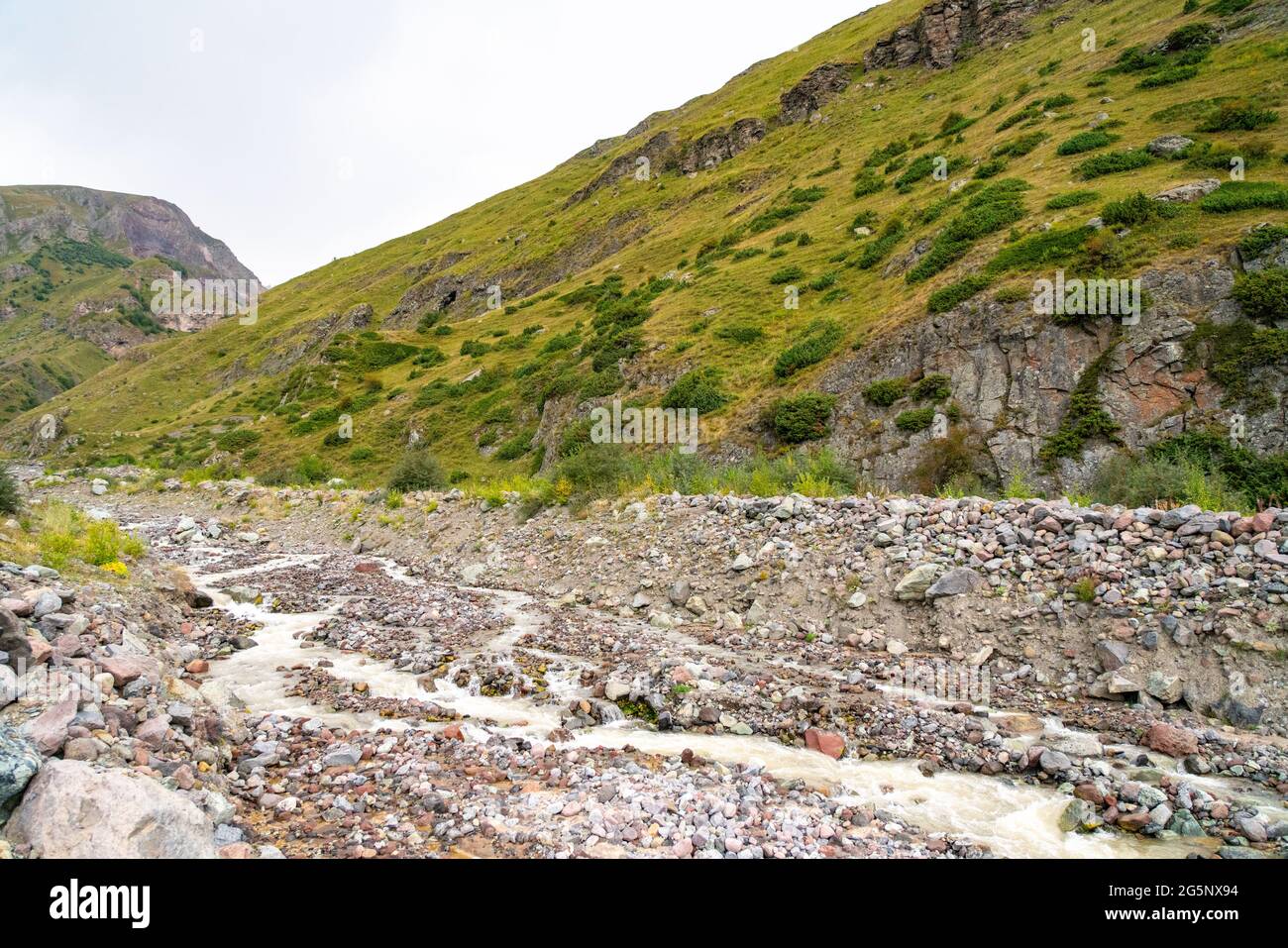 A seething river against the backdrop of mountains and sky Stock Photo ...