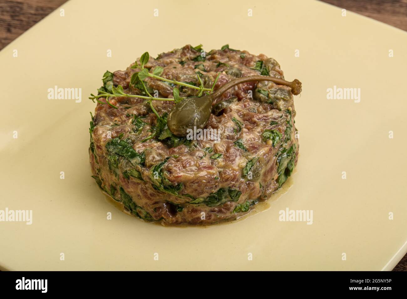 Raw beef tartar snack with capers Stock Photo - Alamy