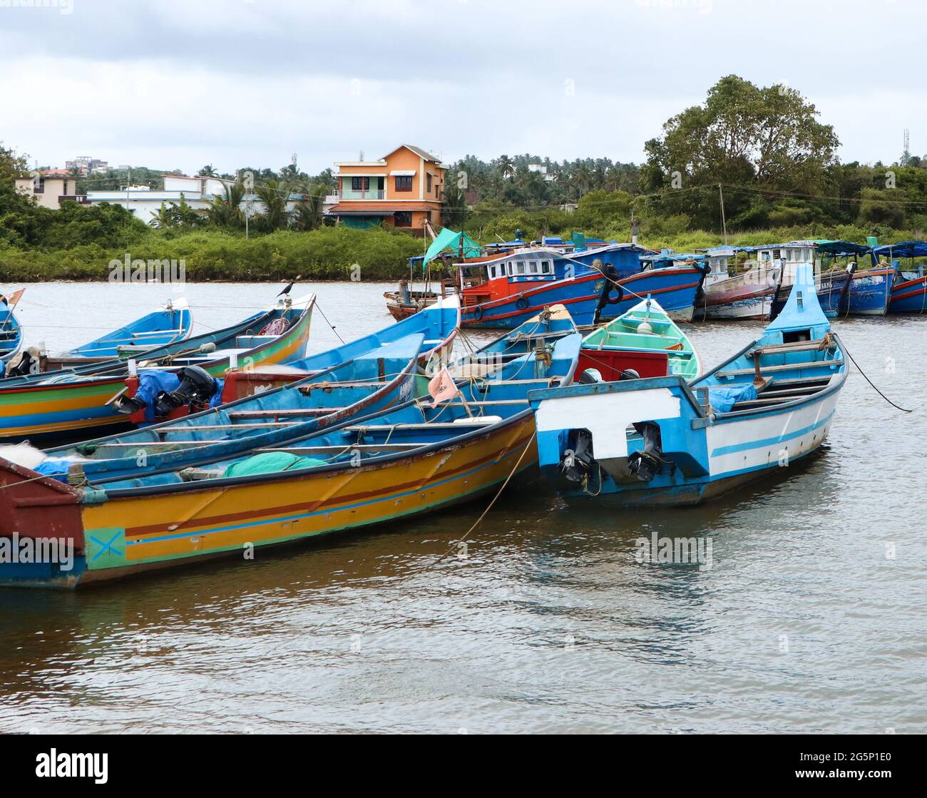 small fishing motor boats lined up in a fishing sea harbor in the ...