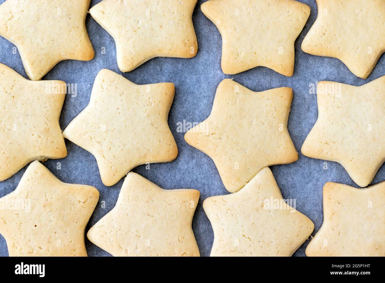 Baked shortbread cookies in the form of stars on a baking sheet with ...
