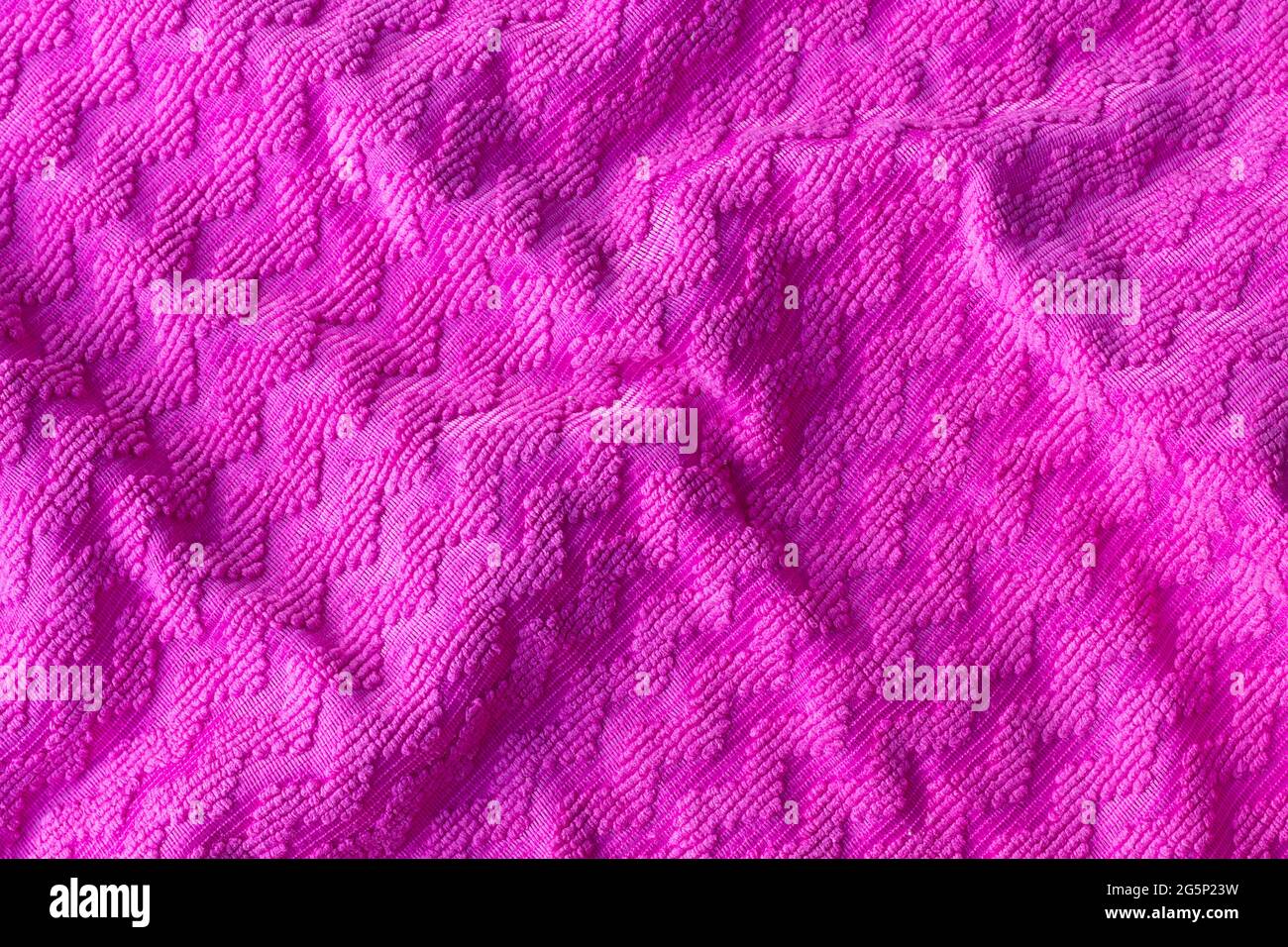 Bright pink fabric texture with zigzag pattern. Crumpled rough textile ...